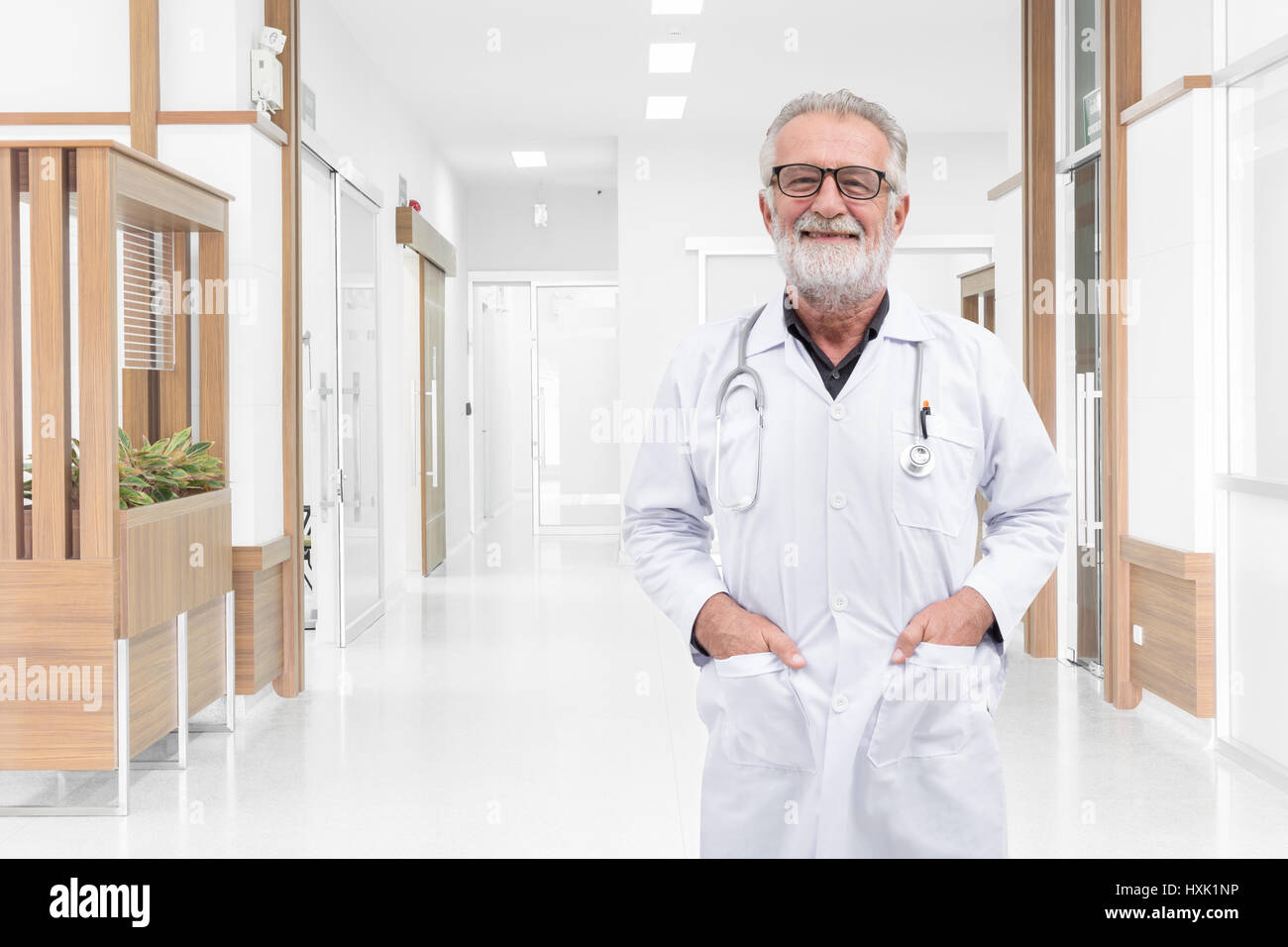 Senior doctor smile in the hospital hallway Stock Photo - Alamy