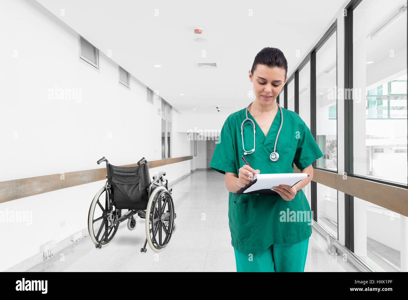 Nurse writing a medical record in the hospital hallway Stock Photo - Alamy