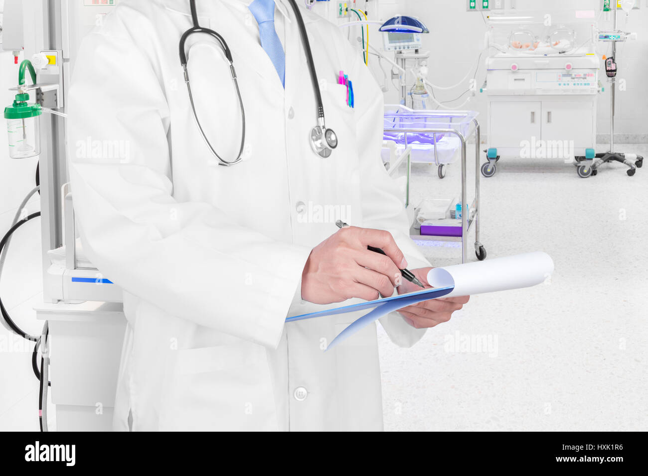 Doctor writing a medical prescription in delivery room Stock Photo - Alamy