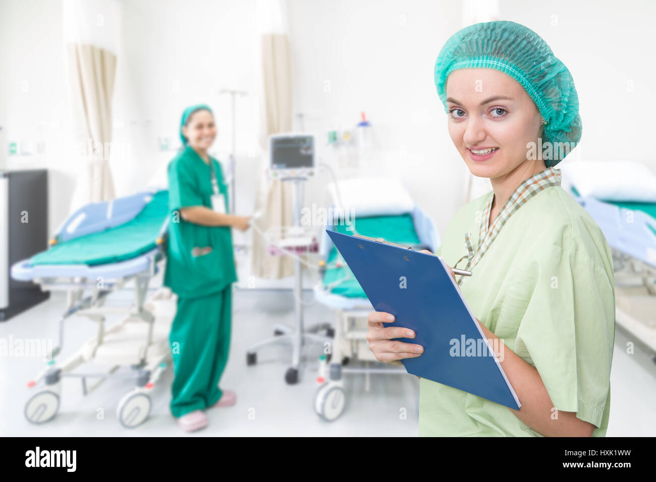 Nurse writing a medical record in the hospital room Stock Photo - Alamy