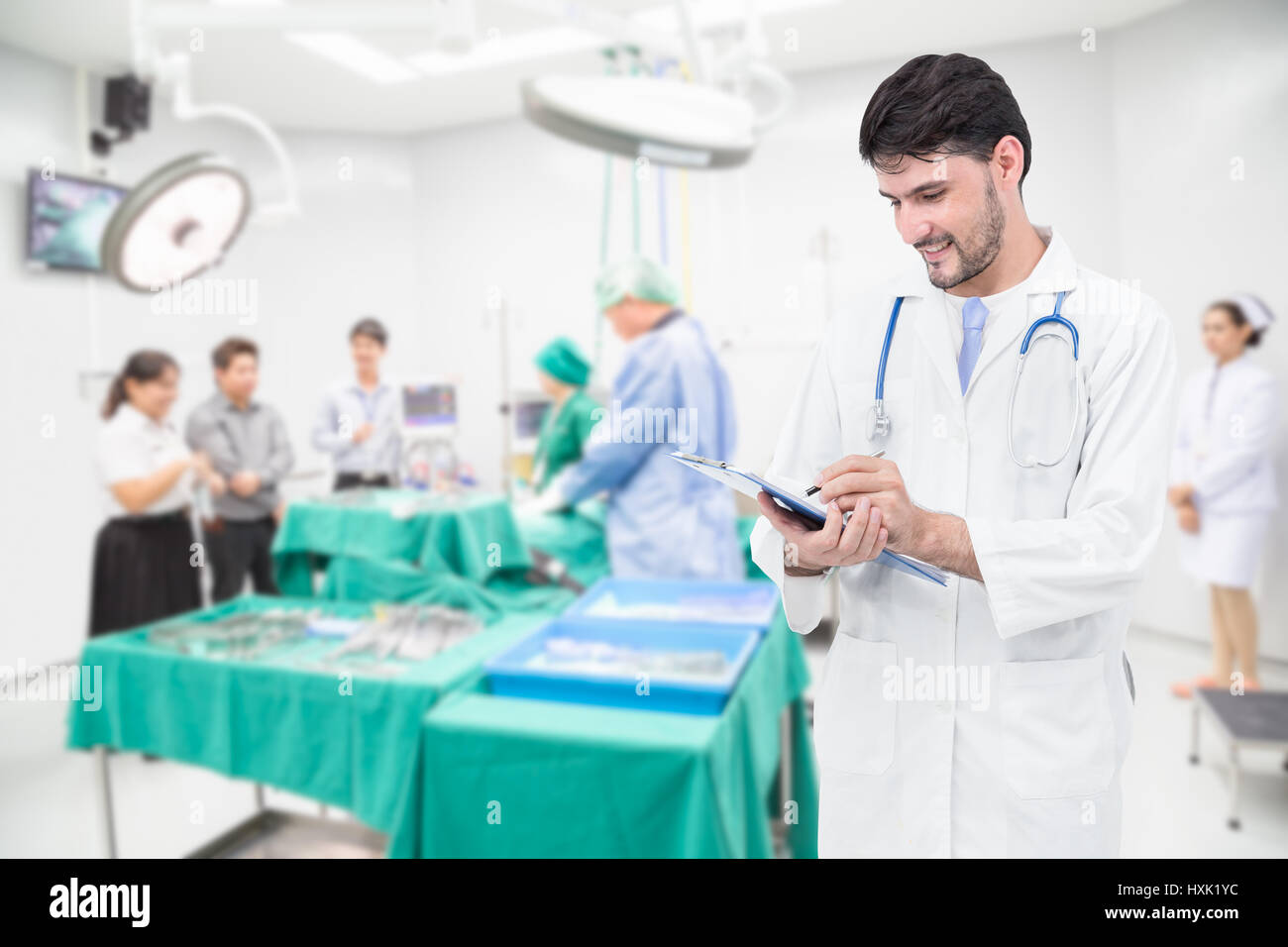 Doctor writing medical records in operating room with beds and ...