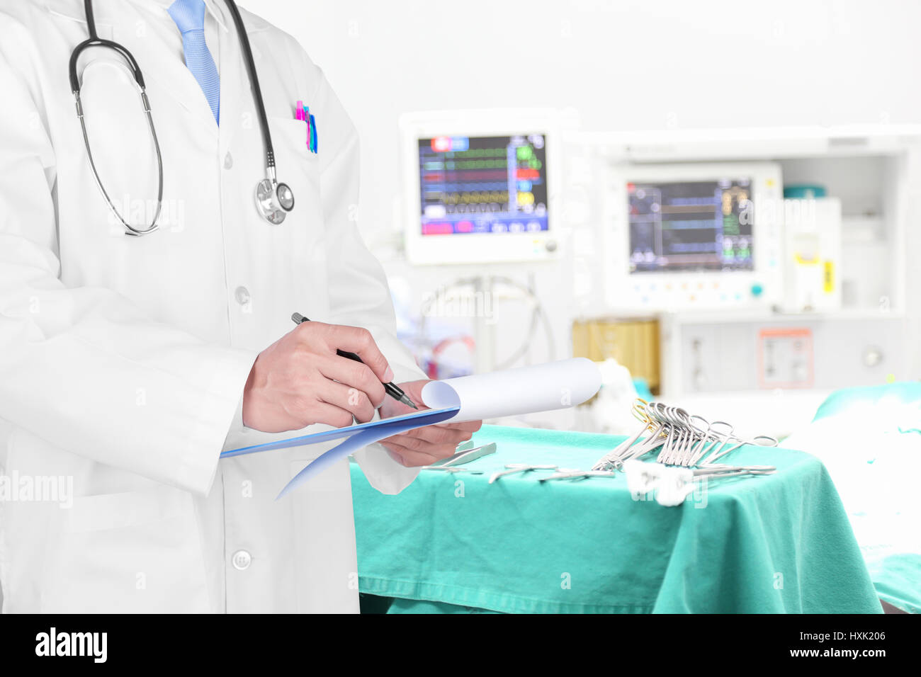 Doctor writing a medical prescription in operating room Stock Photo - Alamy