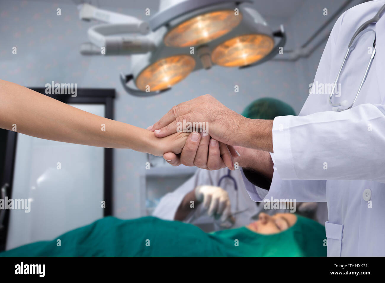 Hand of doctors to reassuring relatives of the patient that the ...