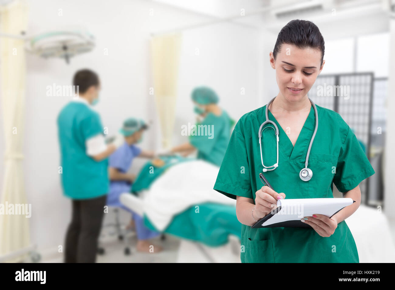 Nurse writing a medical record in operating room Stock Photo - Alamy