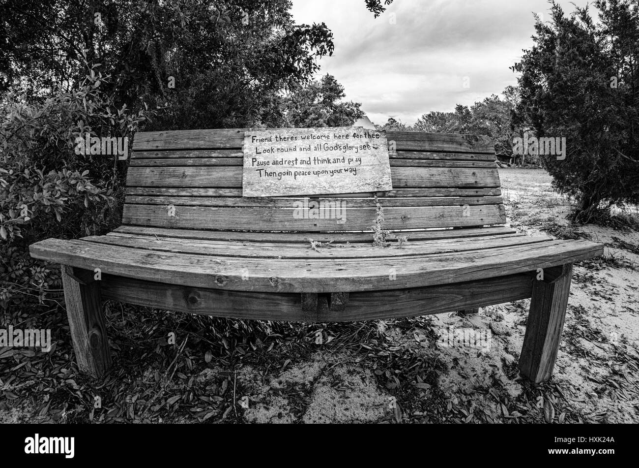 Sign on a Bench along a walkway on a beach shot with a fisheye lens ...