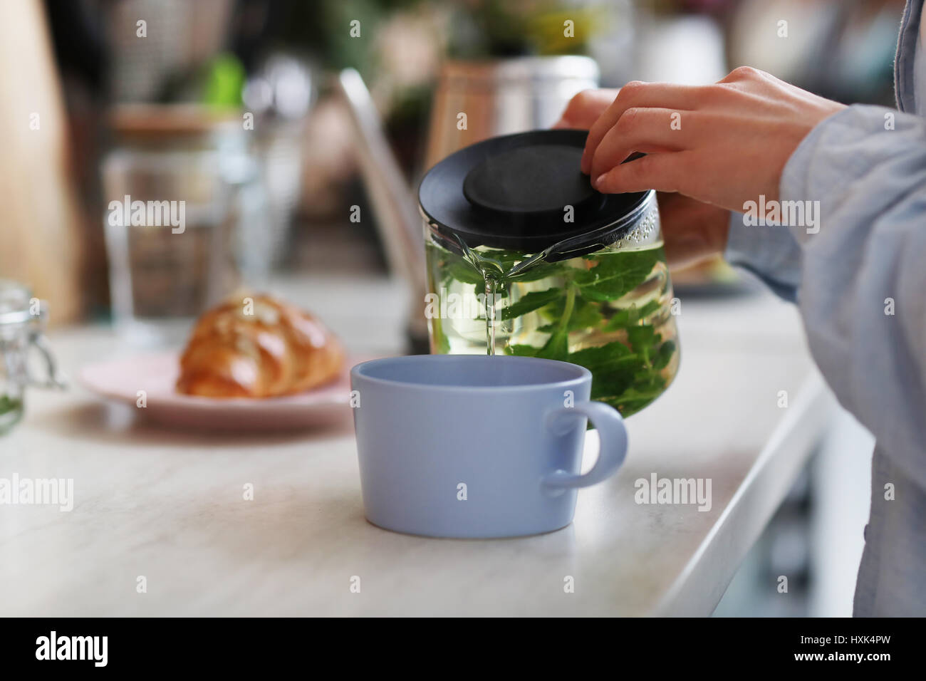 Home. Woman making tea in kitchen Stock Photo - Alamy