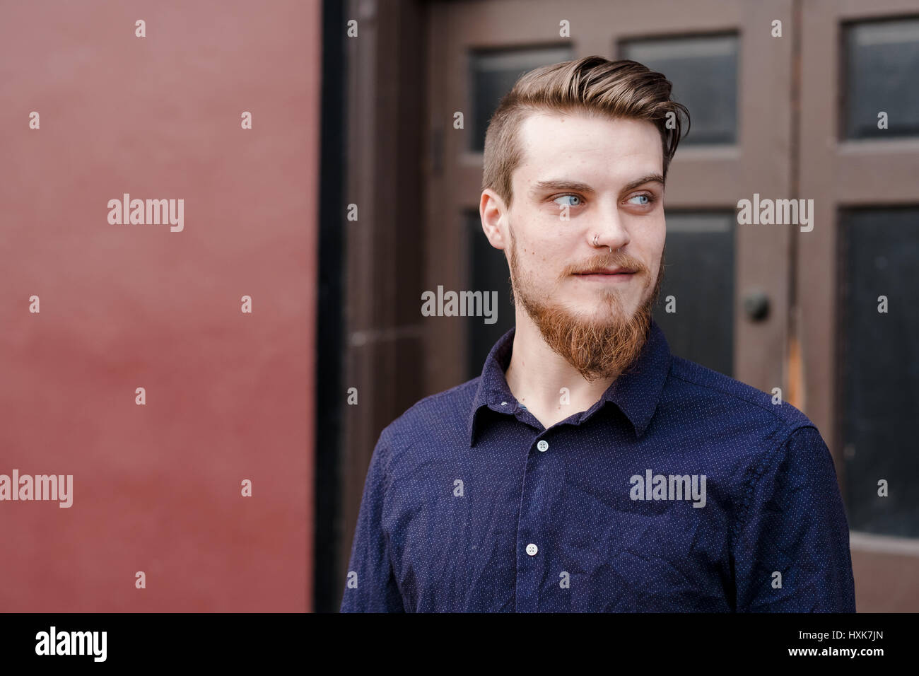 Hipster posing outdoors for the camera with a fashion forward style and ...