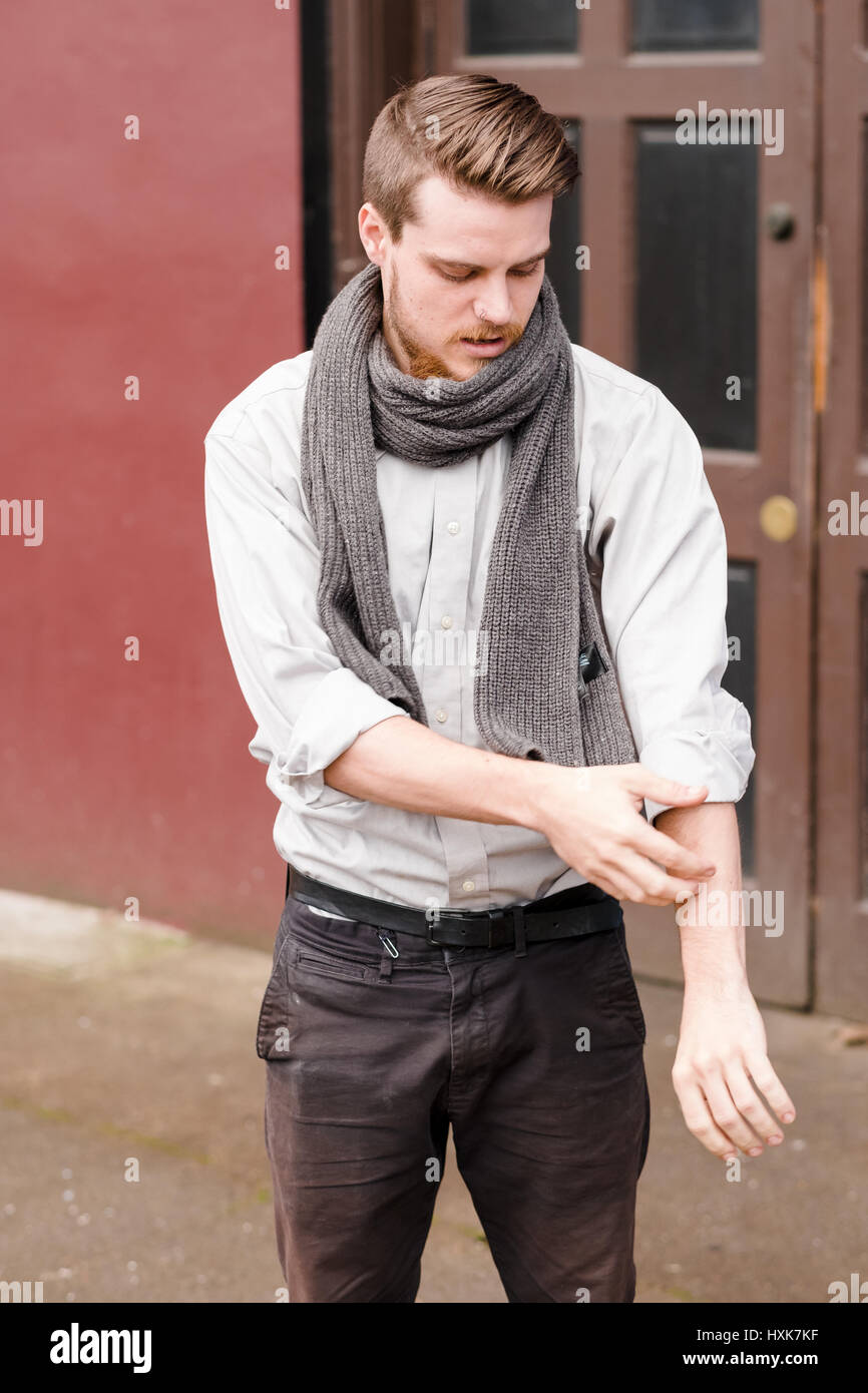 Hipster posing outdoors for the camera with a fashion forward style and ...