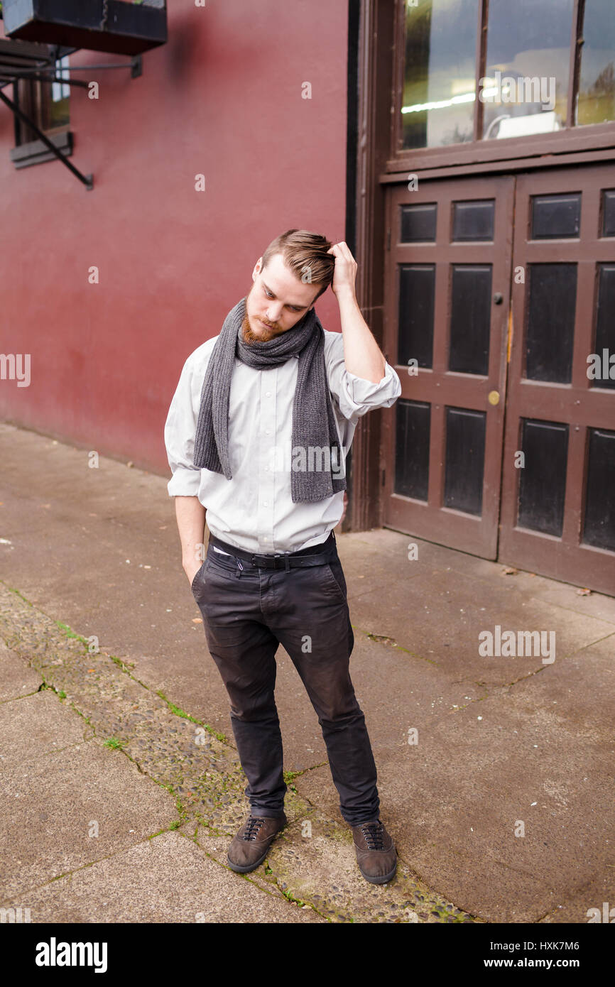 Hipster posing outdoors for the camera with a fashion forward style and ...