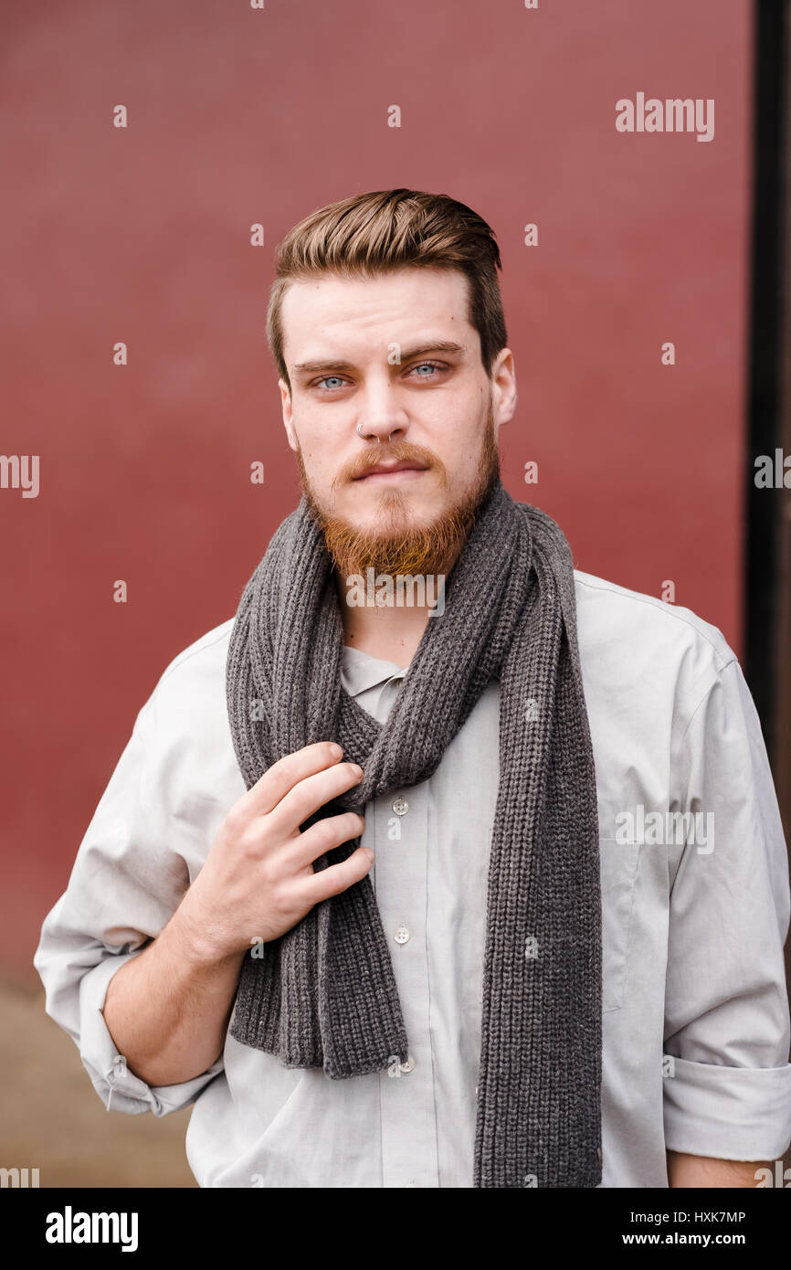 Hipster posing outdoors for the camera with a fashion forward style and ...