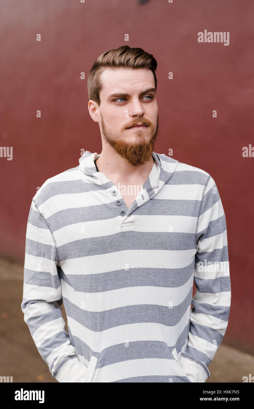 Hipster posing outdoors for the camera with a fashion forward style and ...