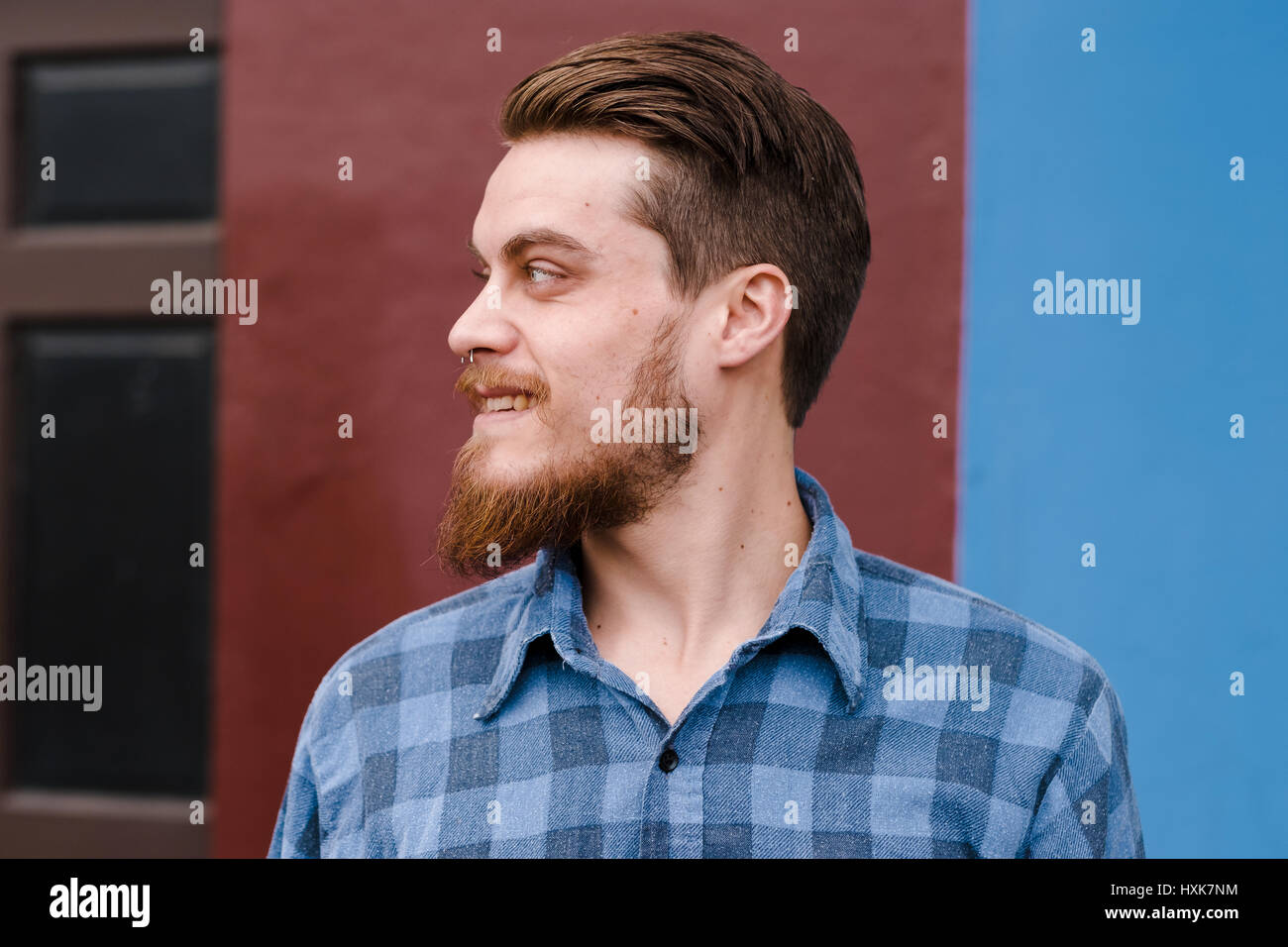 Hipster posing outdoors for the camera with a fashion forward style and ...