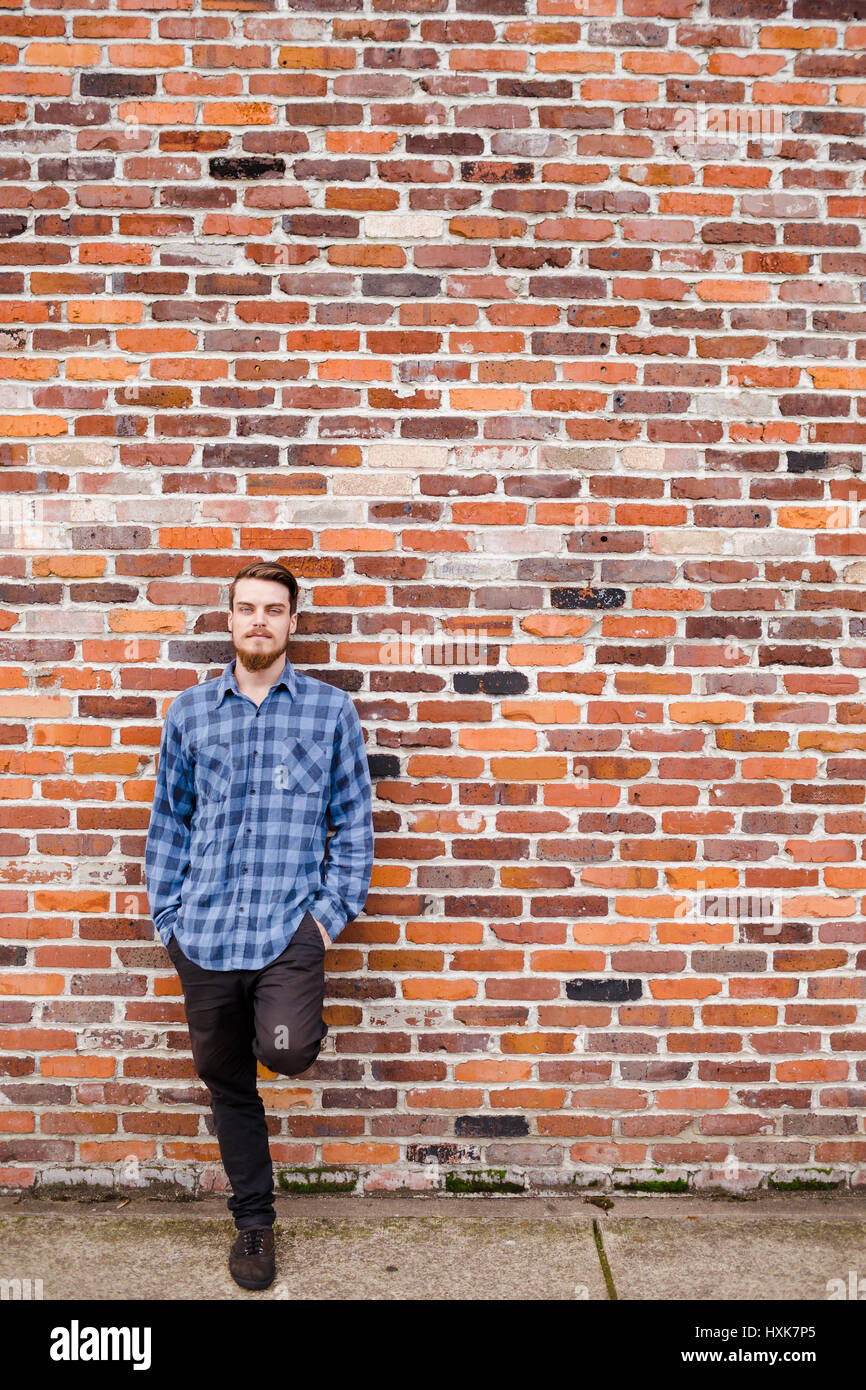 Hipster posing outdoors for the camera with a fashion forward style and ...
