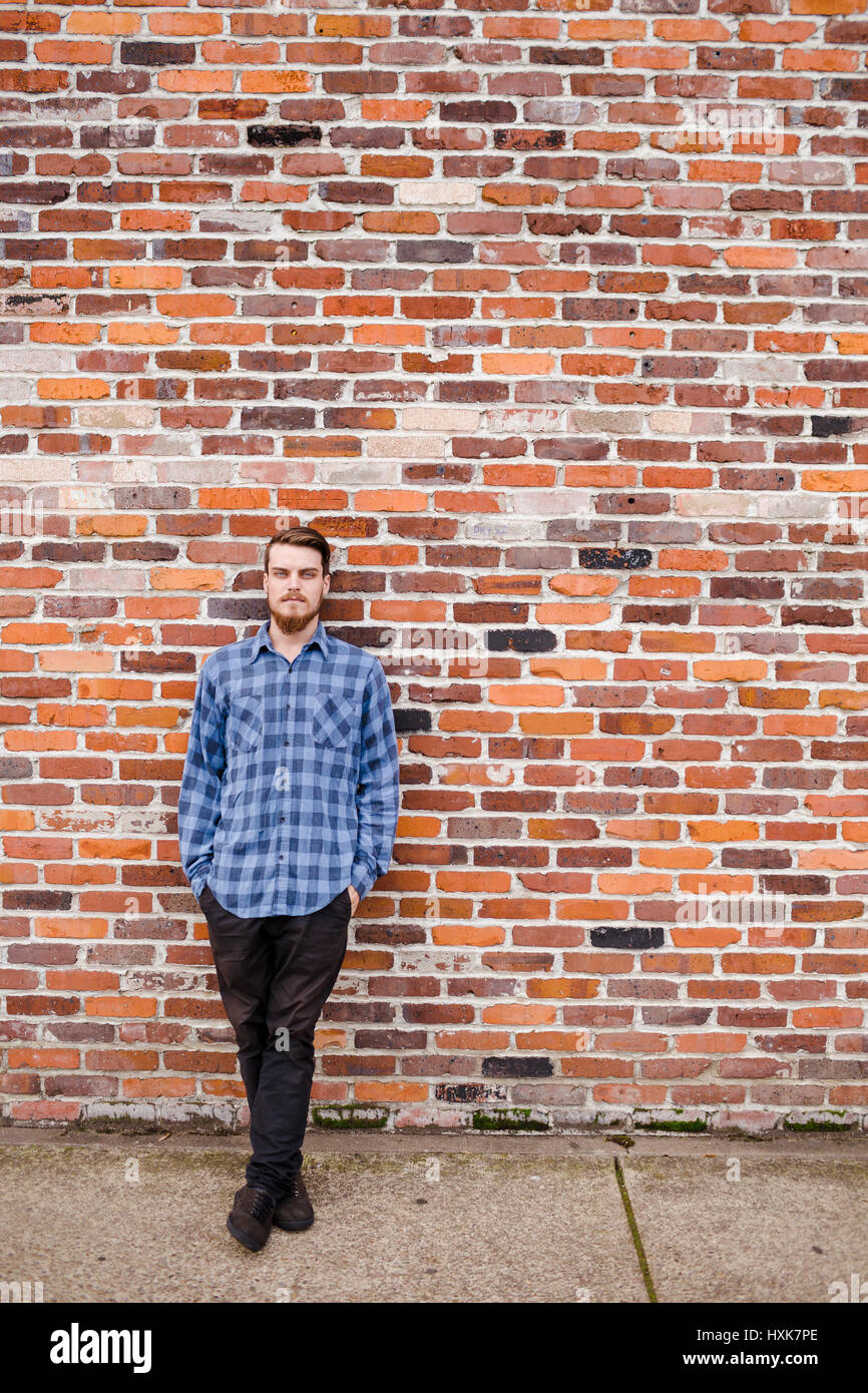 Hipster posing outdoors for the camera with a fashion forward style and ...