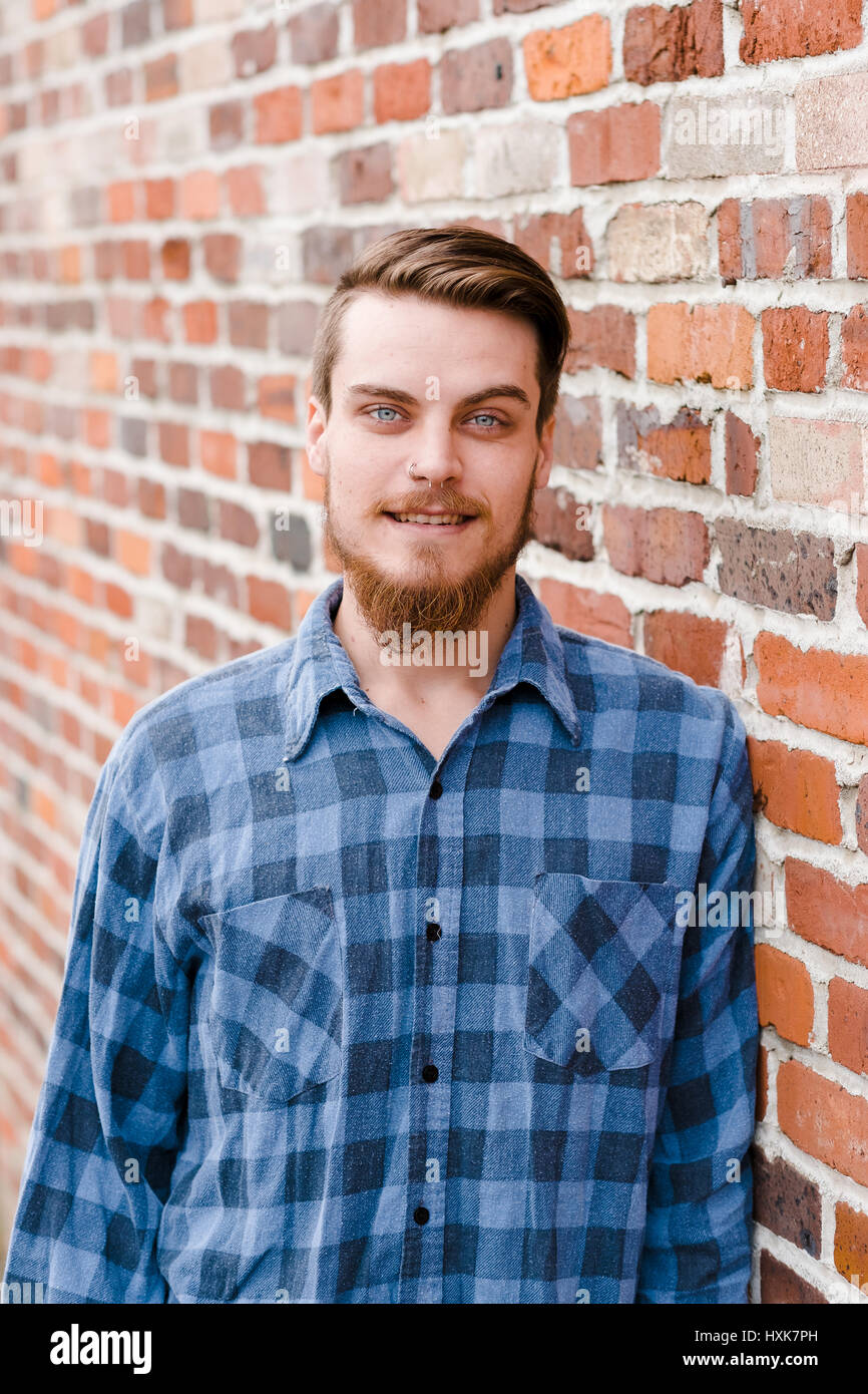Hipster posing outdoors for the camera with a fashion forward style and ...