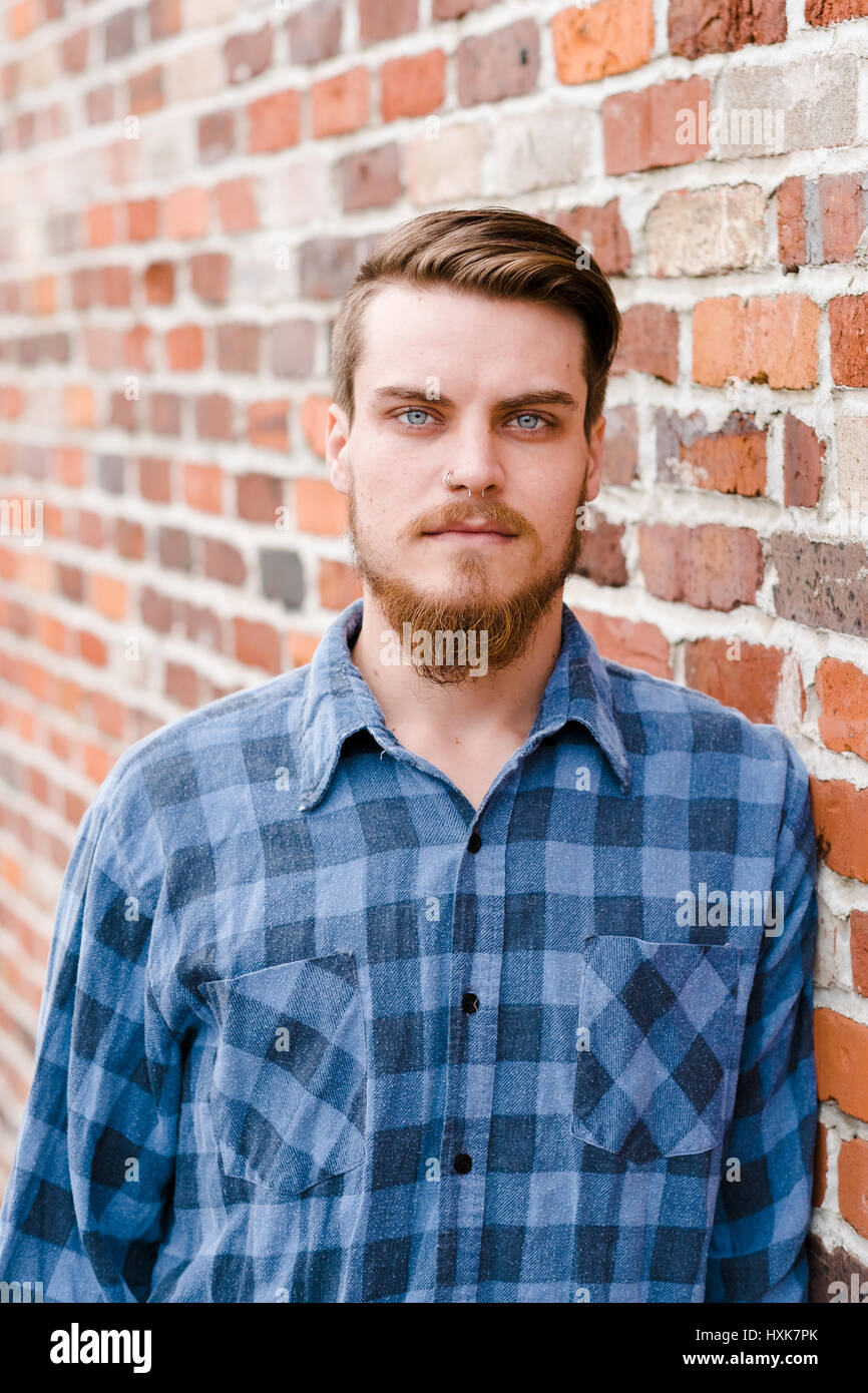 Hipster posing outdoors for the camera with a fashion forward style and ...