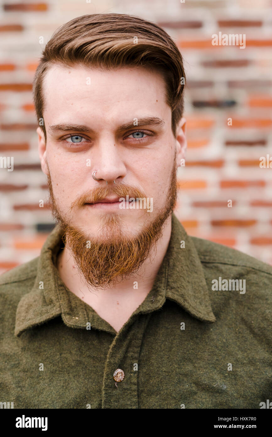 Hipster posing outdoors for the camera with a fashion forward style and ...
