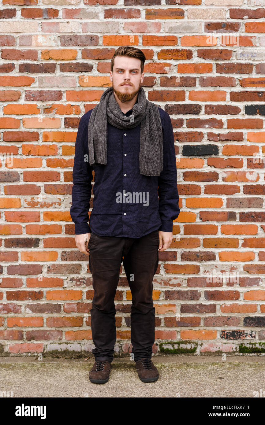 Hipster posing outdoors for the camera with a fashion forward style and ...