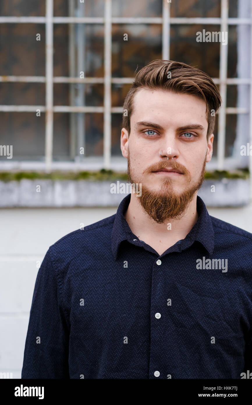 Hipster posing outdoors for the camera with a fashion forward style and ...