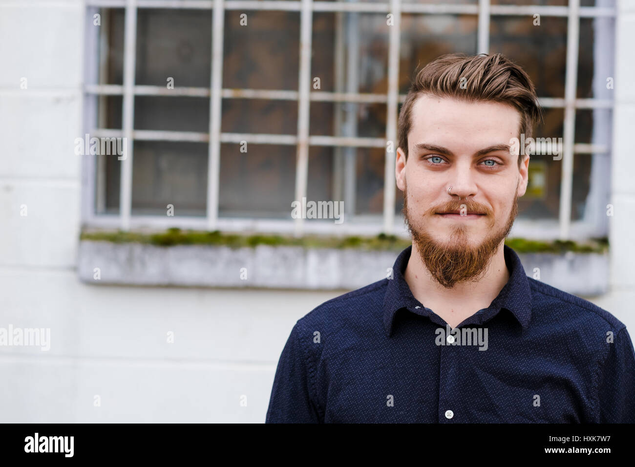 Hipster posing outdoors for the camera with a fashion forward style and ...