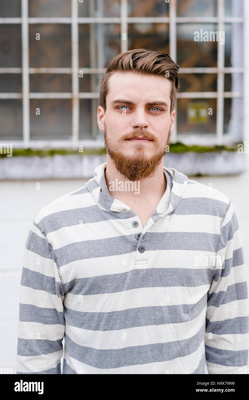 Hipster posing outdoors for the camera with a fashion forward style and ...