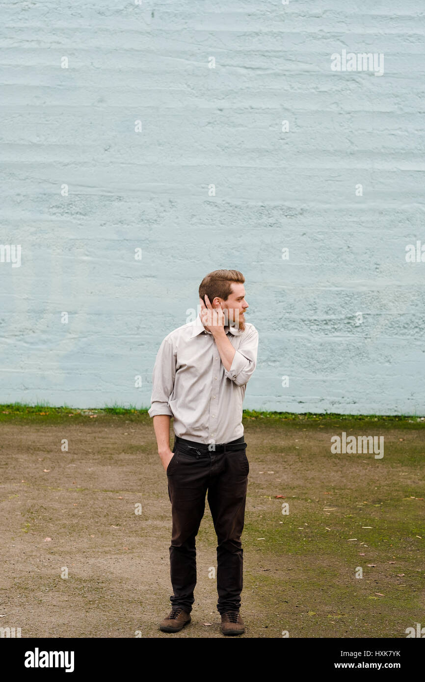 Hipster posing outdoors for the camera with a fashion forward style and ...