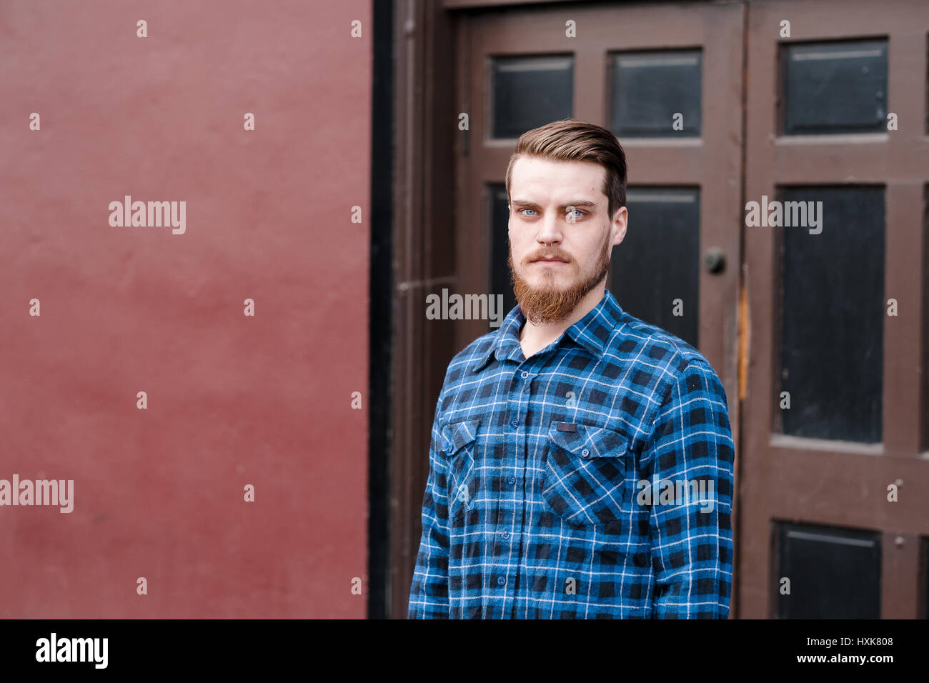 Hipster posing outdoors for the camera with a fashion forward style and ...