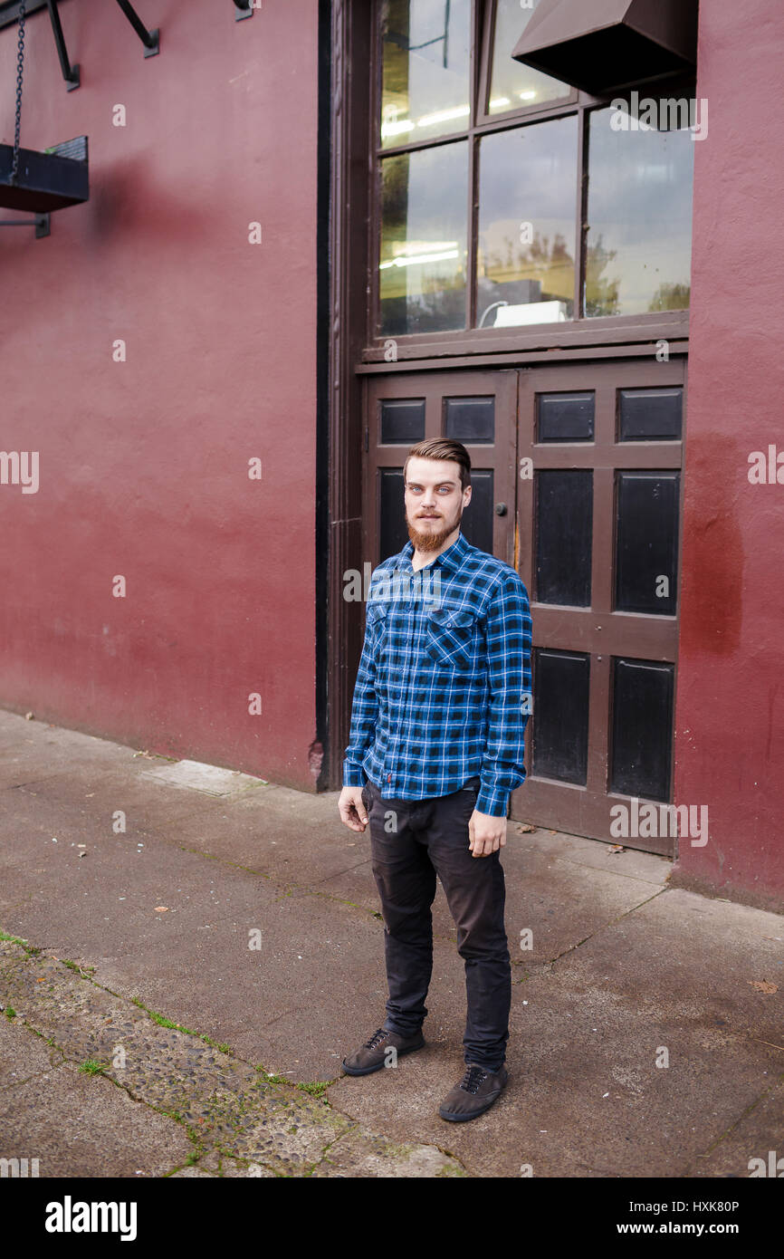 Hipster posing outdoors for the camera with a fashion forward style and ...