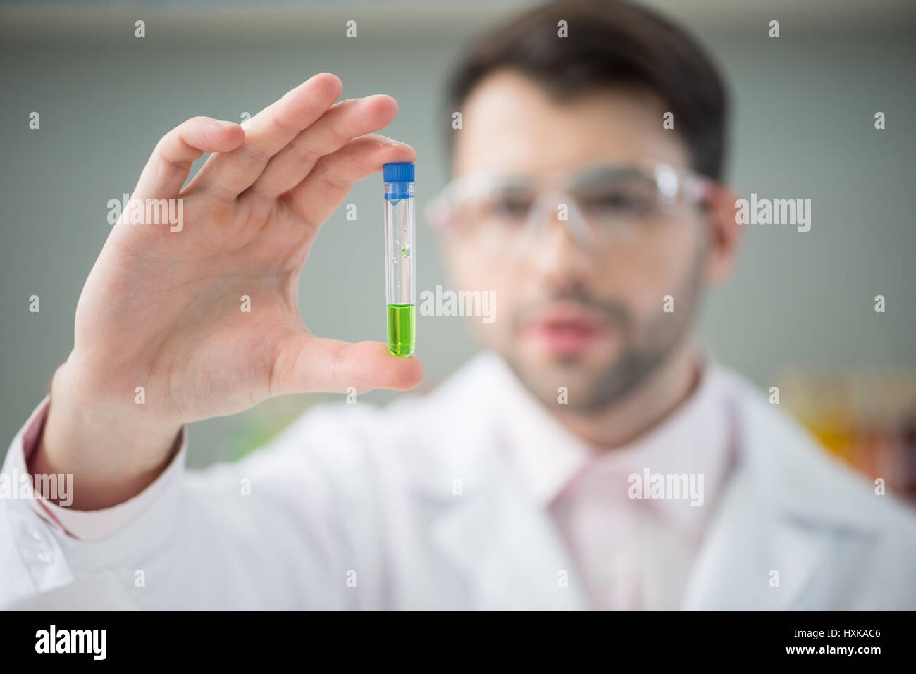 man scientist holding glass tube in hand in lab Stock Photo - Alamy