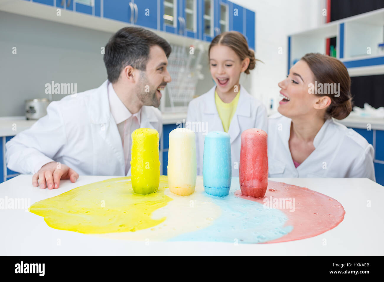 portrait of cheerful teachers and girl student scientists making ...