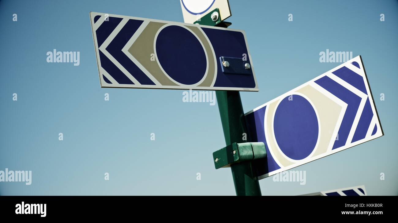 Directional signals in a pole with blue sky Stock Photo - Alamy