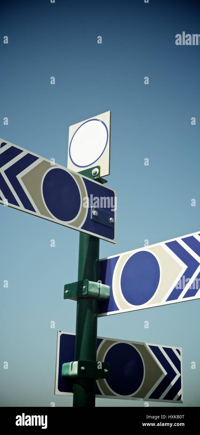 Directional signals in a pole with blue sky Stock Photo - Alamy
