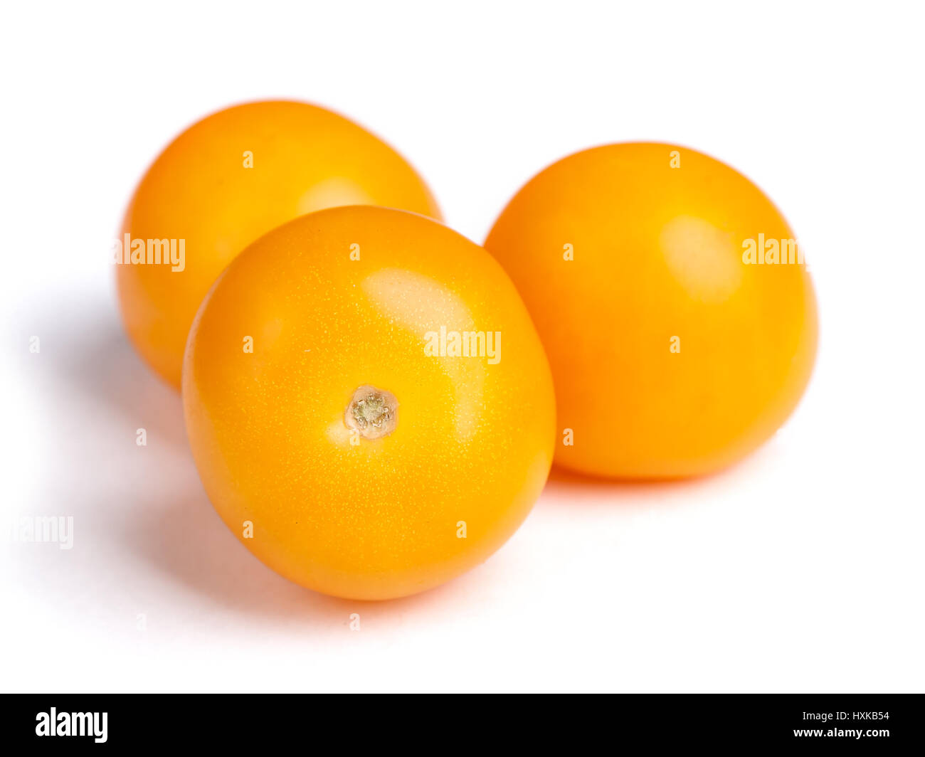 Heap of yellow tomatoes isolated on white background Stock Photo - Alamy