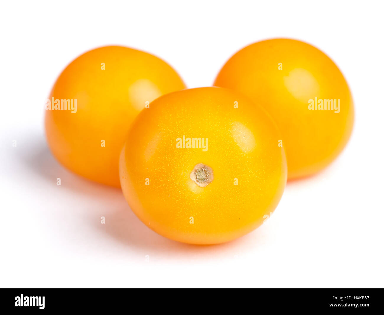 Heap of yellow tomatoes isolated on white background Stock Photo - Alamy