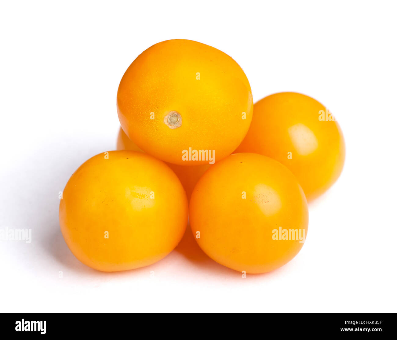 Heap of yellow tomatoes isolated on white background Stock Photo - Alamy
