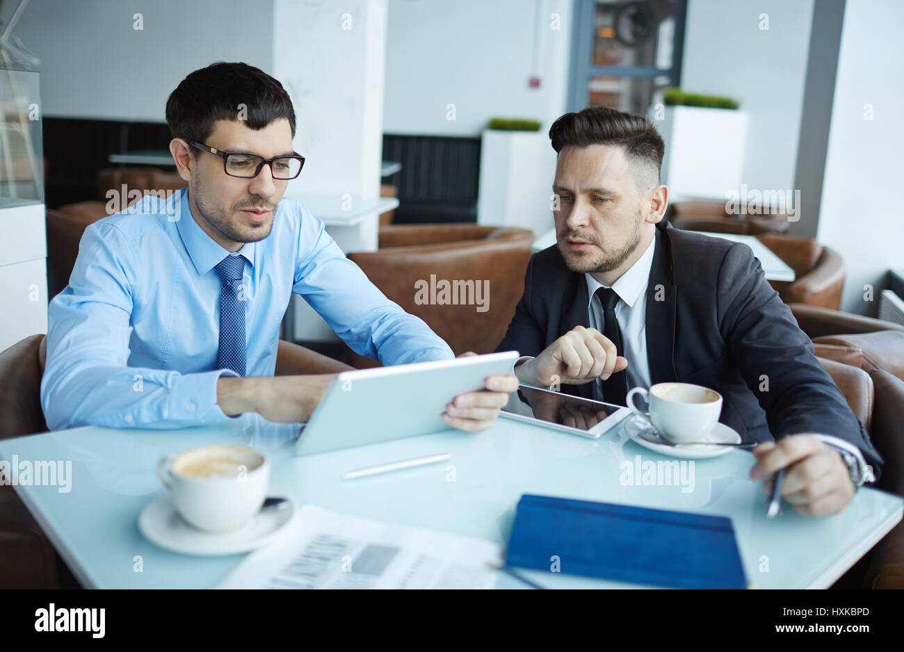 Concentrated Businessmen Analyzing Work Results Stock Photo - Alamy