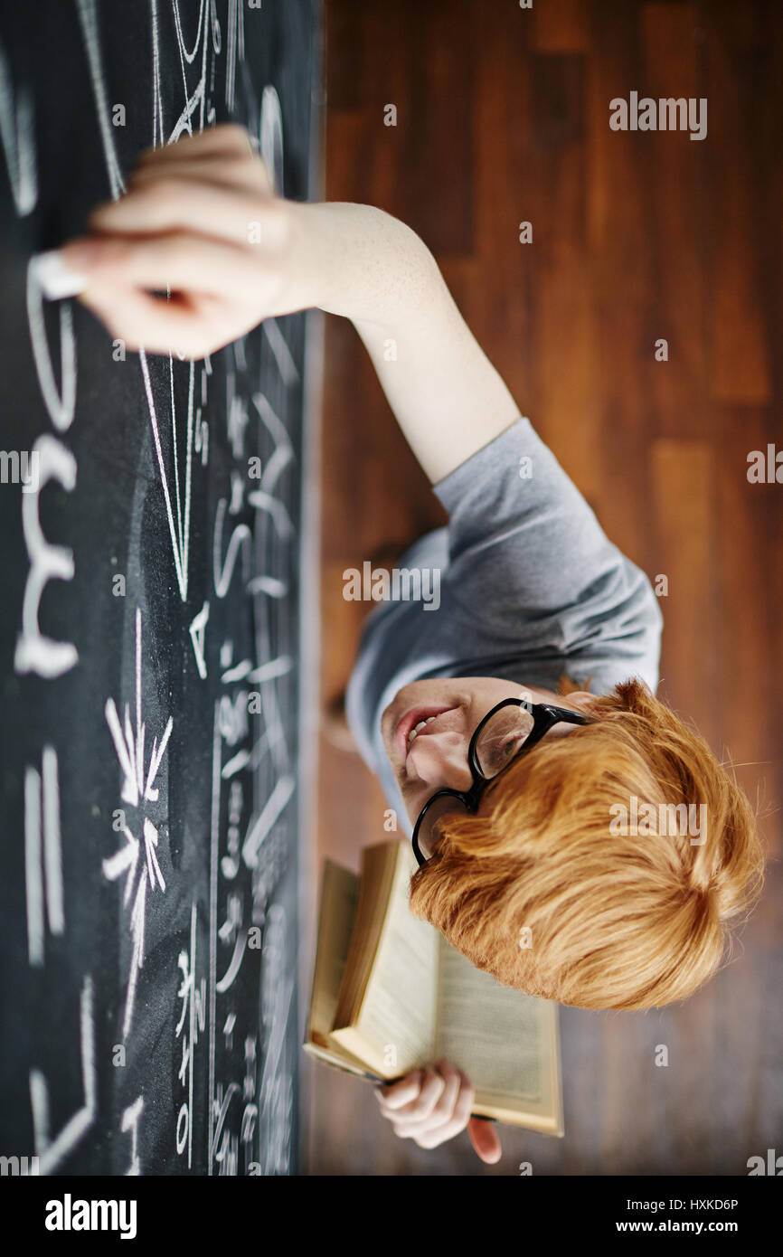 Science Student Writing on Blackboard Stock Photo - Alamy