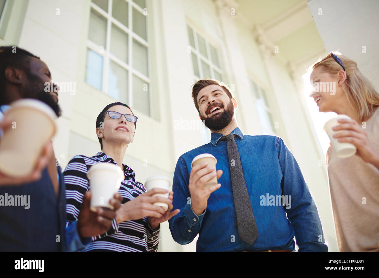 Having small talk during coffee break Stock Photo - Alamy