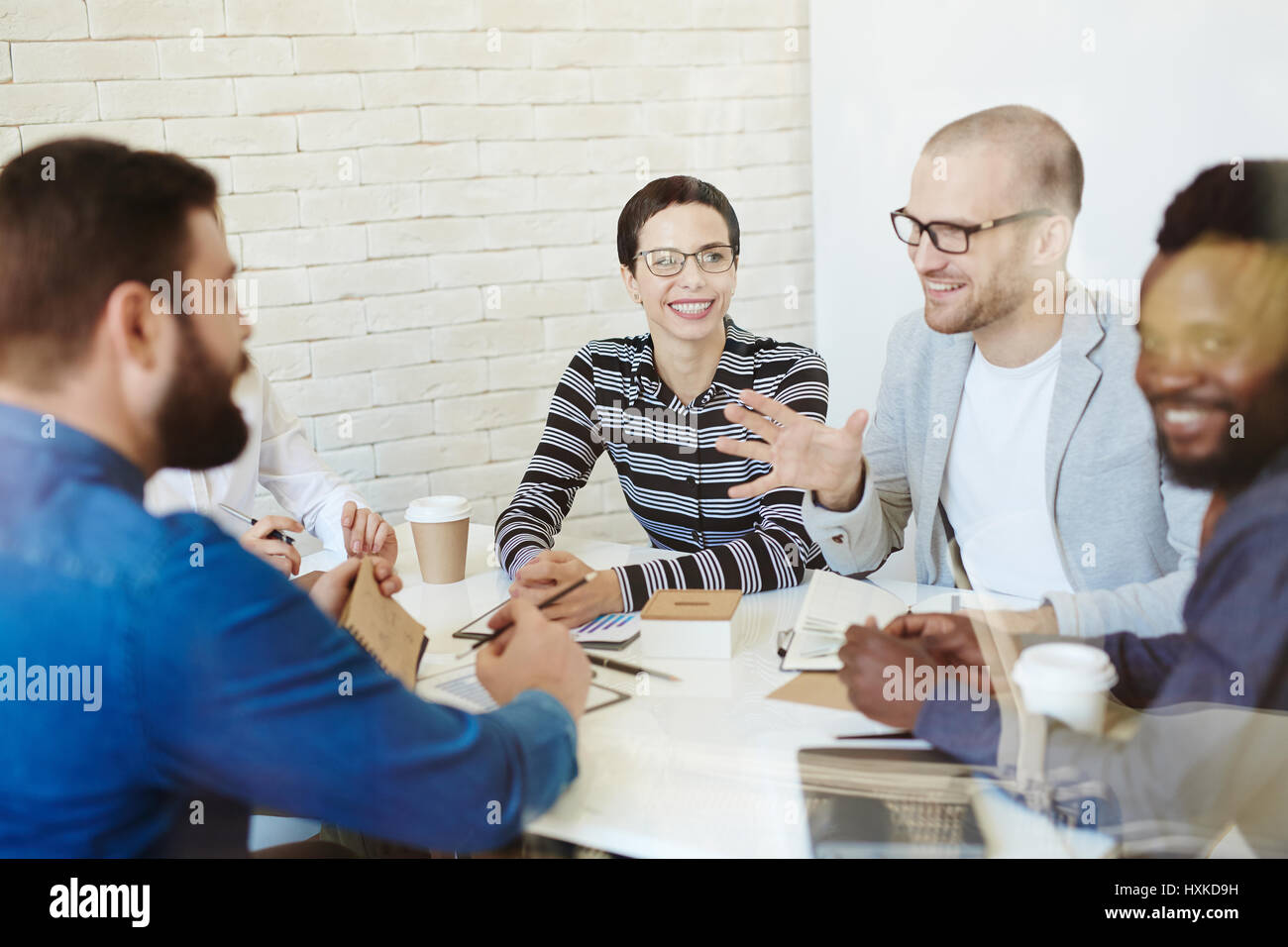 Cheerful businesspeople having project discussion Stock Photo - Alamy