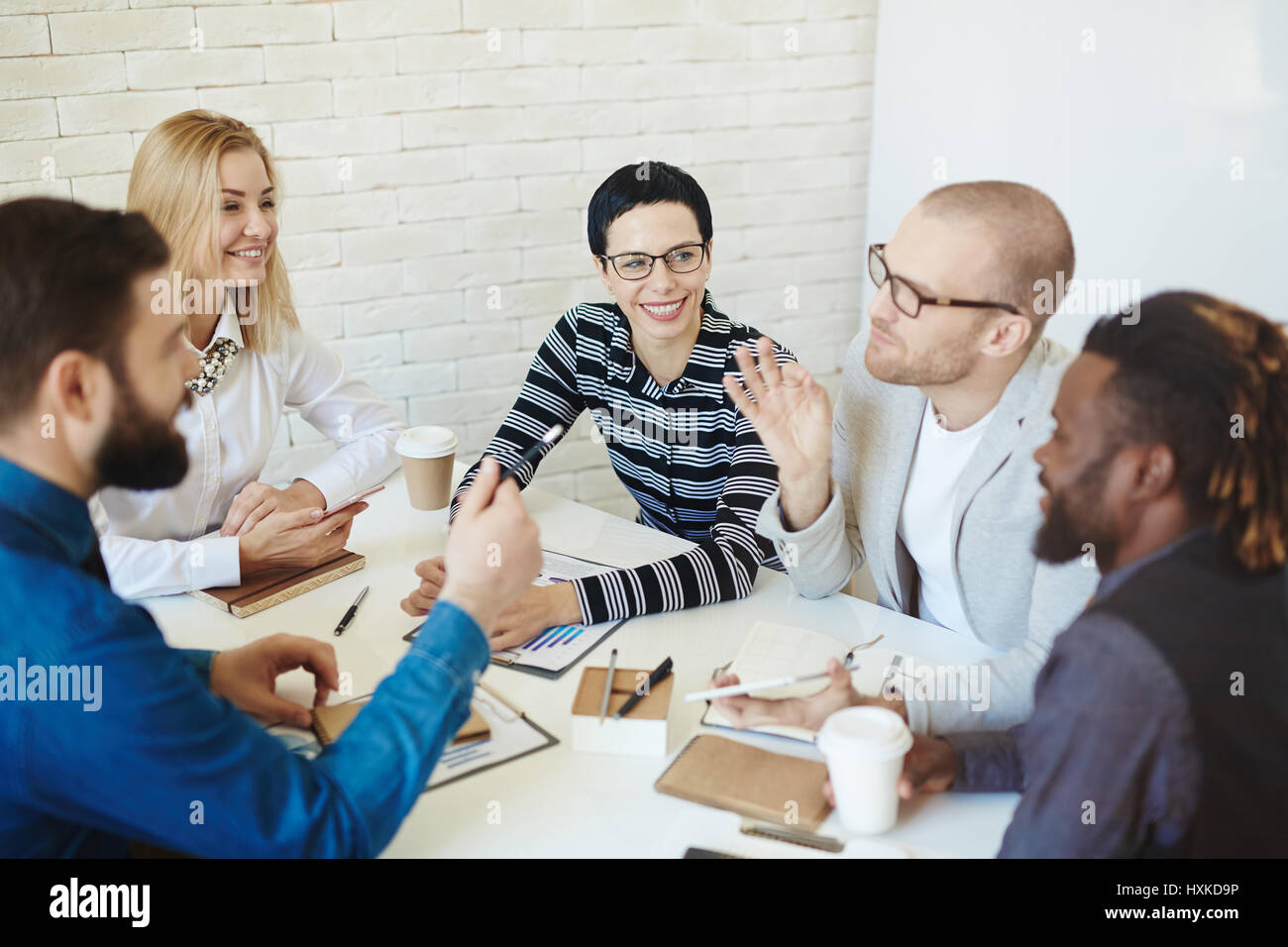 Discussing topical issue in boardroom Stock Photo - Alamy
