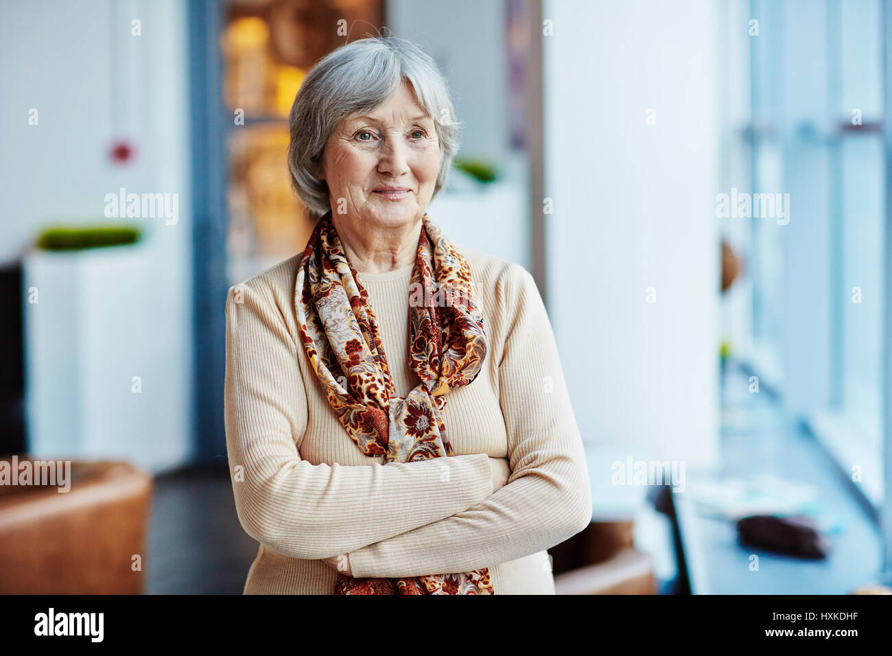 Senior woman standing indoors Stock Photo - Alamy