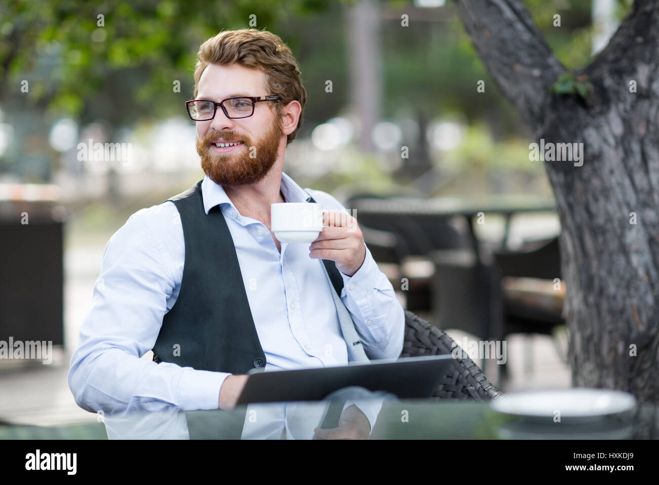 Financial manager working from outdoor cafe Stock Photo - Alamy