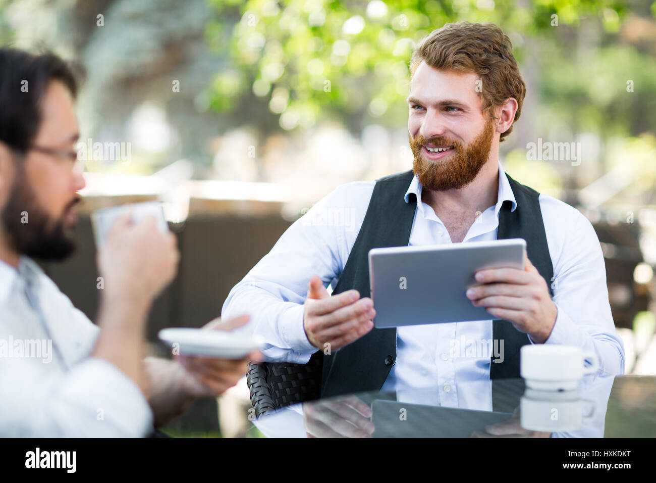 Businessman talking colleague cafe table hi-res stock photography and ...
