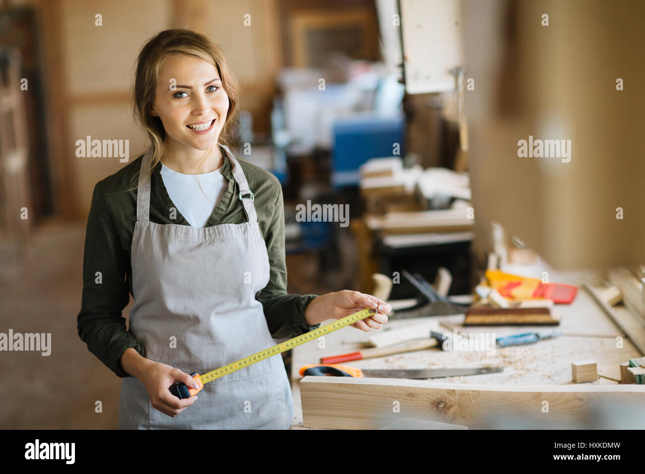 Female woodworker with tape measure Stock Photo - Alamy