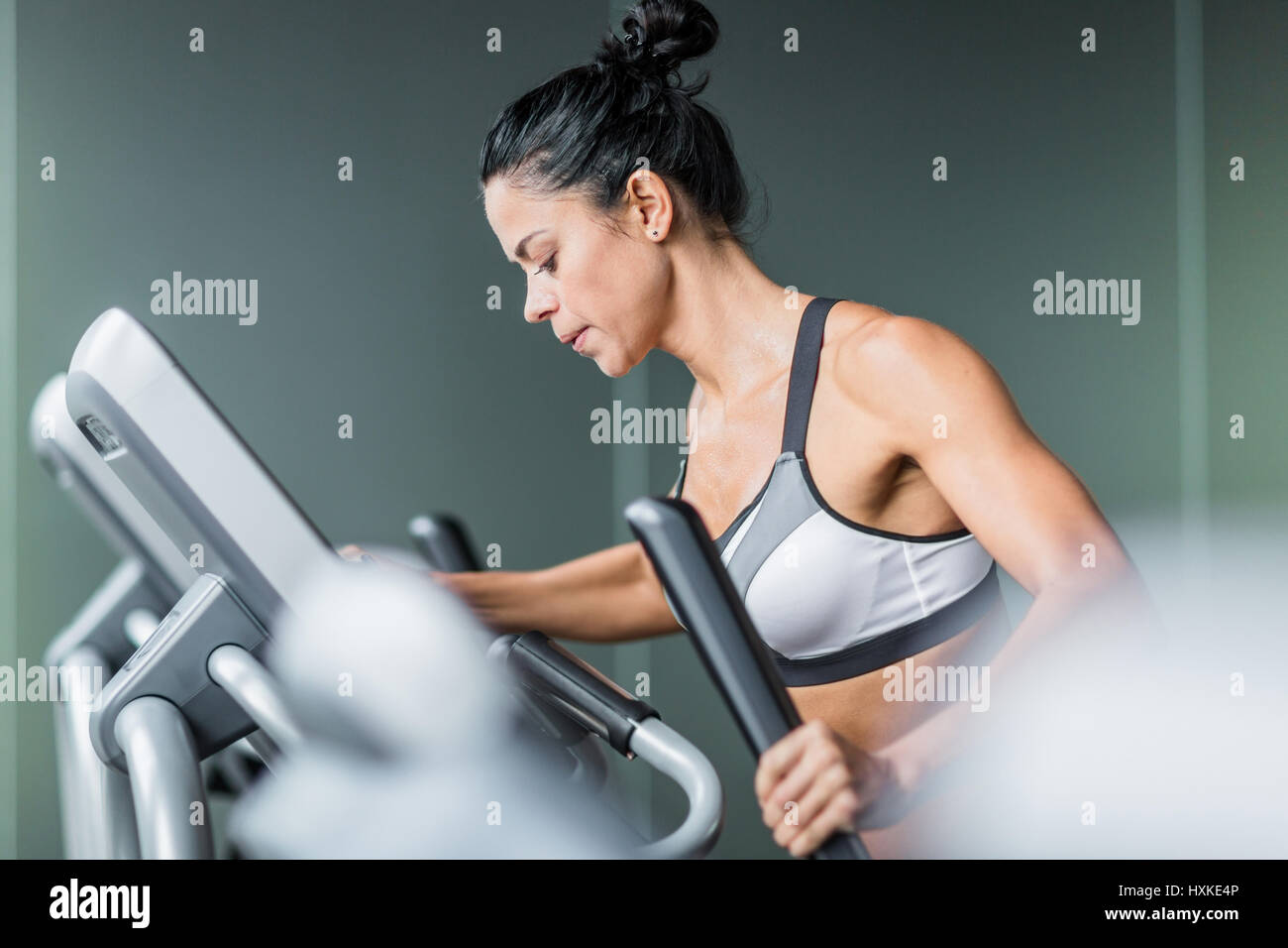 Woman training on elliptical hi-res stock photography and images - Alamy