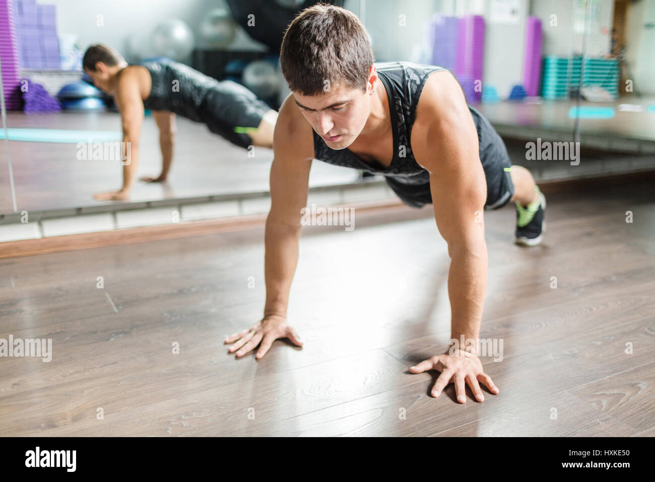 Muscular Man doing Push Ups in Fitness Studio Stock Photo - Alamy