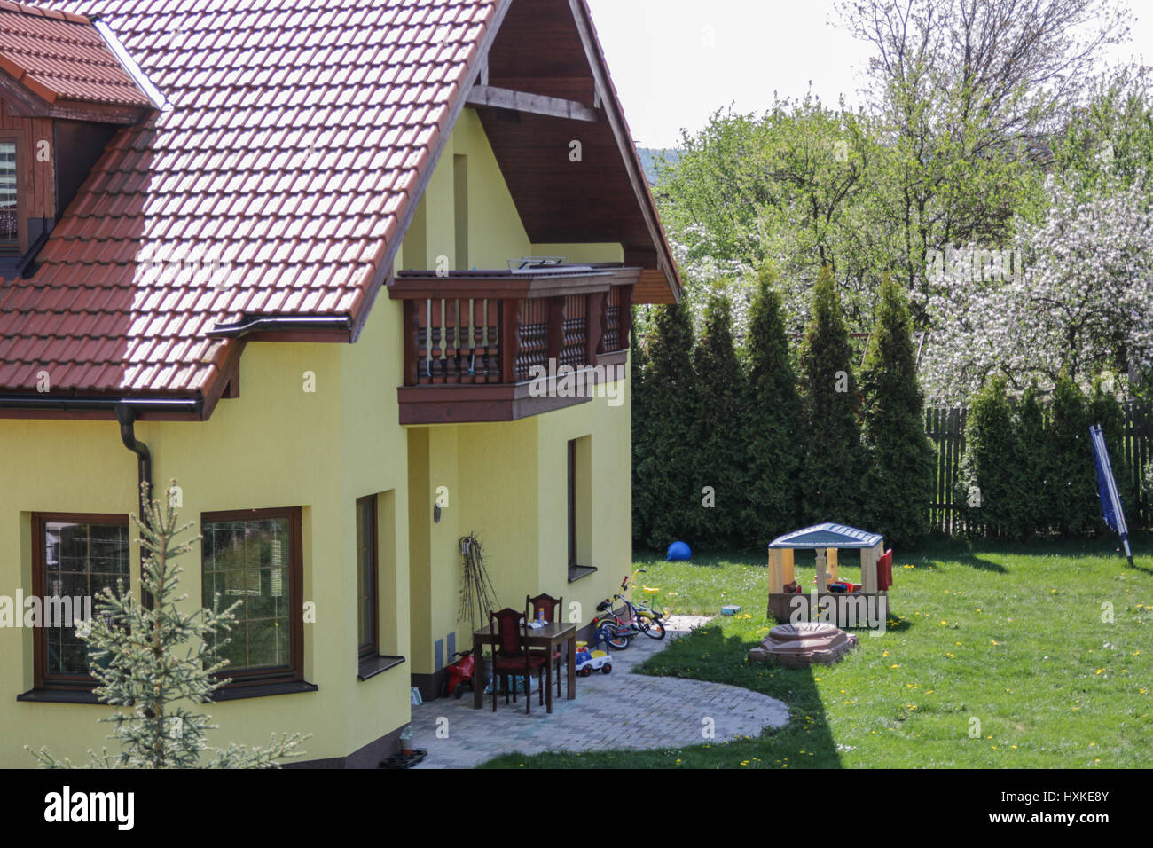 Courtyard with children things on green lawn Stock Photo - Alamy