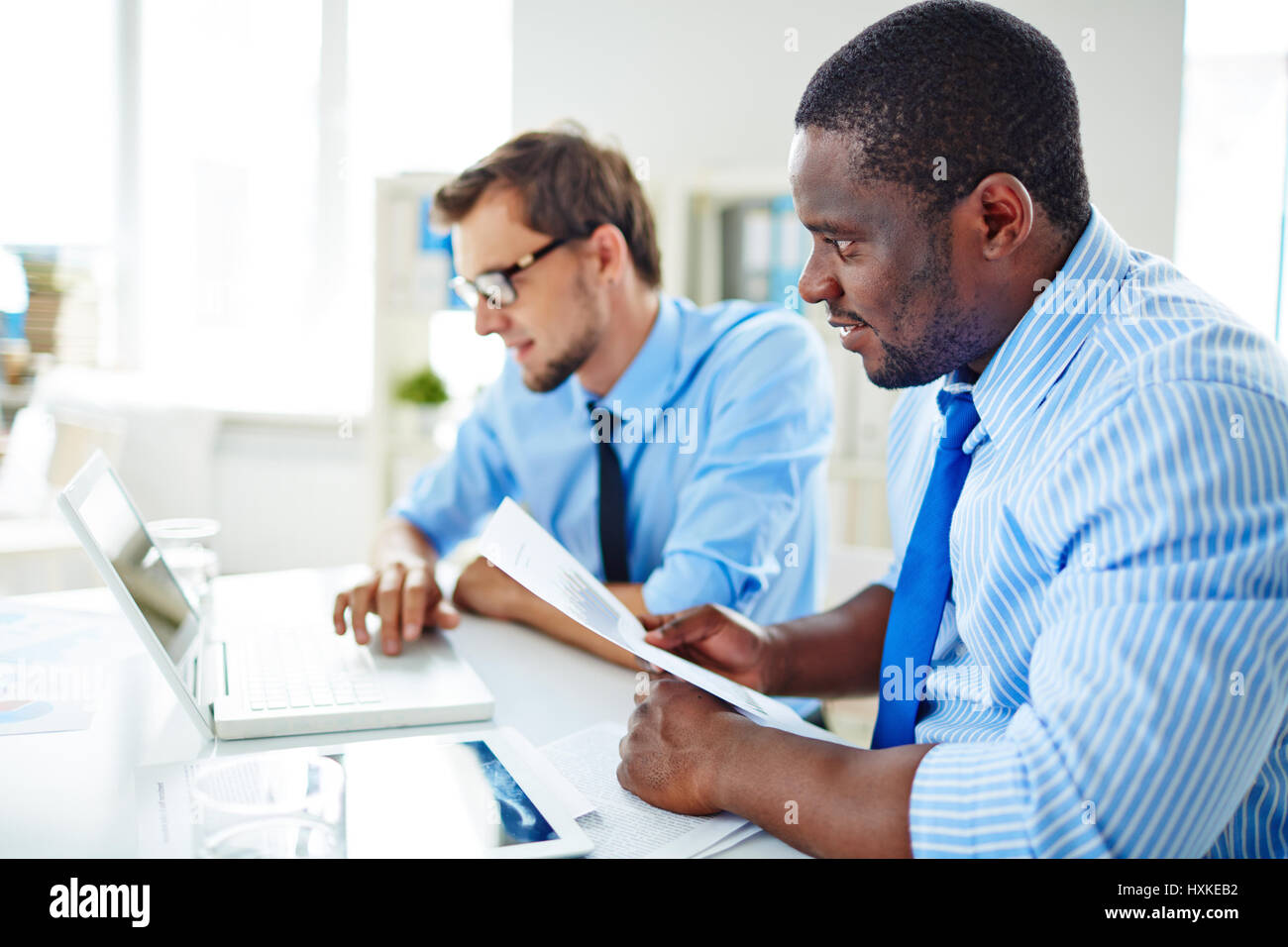 Hard-working employees in boardroom Stock Photo - Alamy