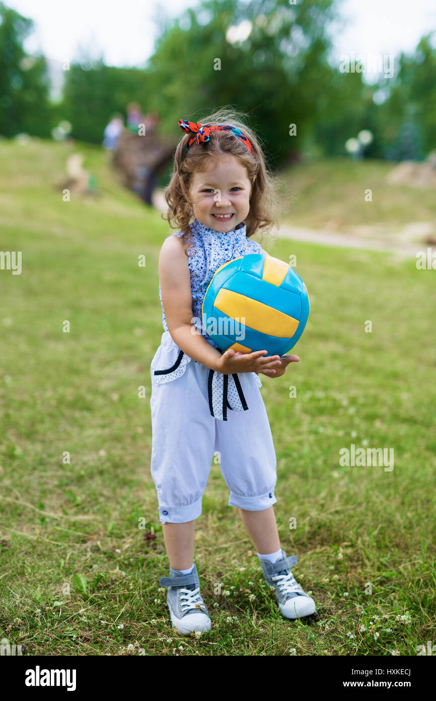 Cute girl with ball Stock Photo - Alamy