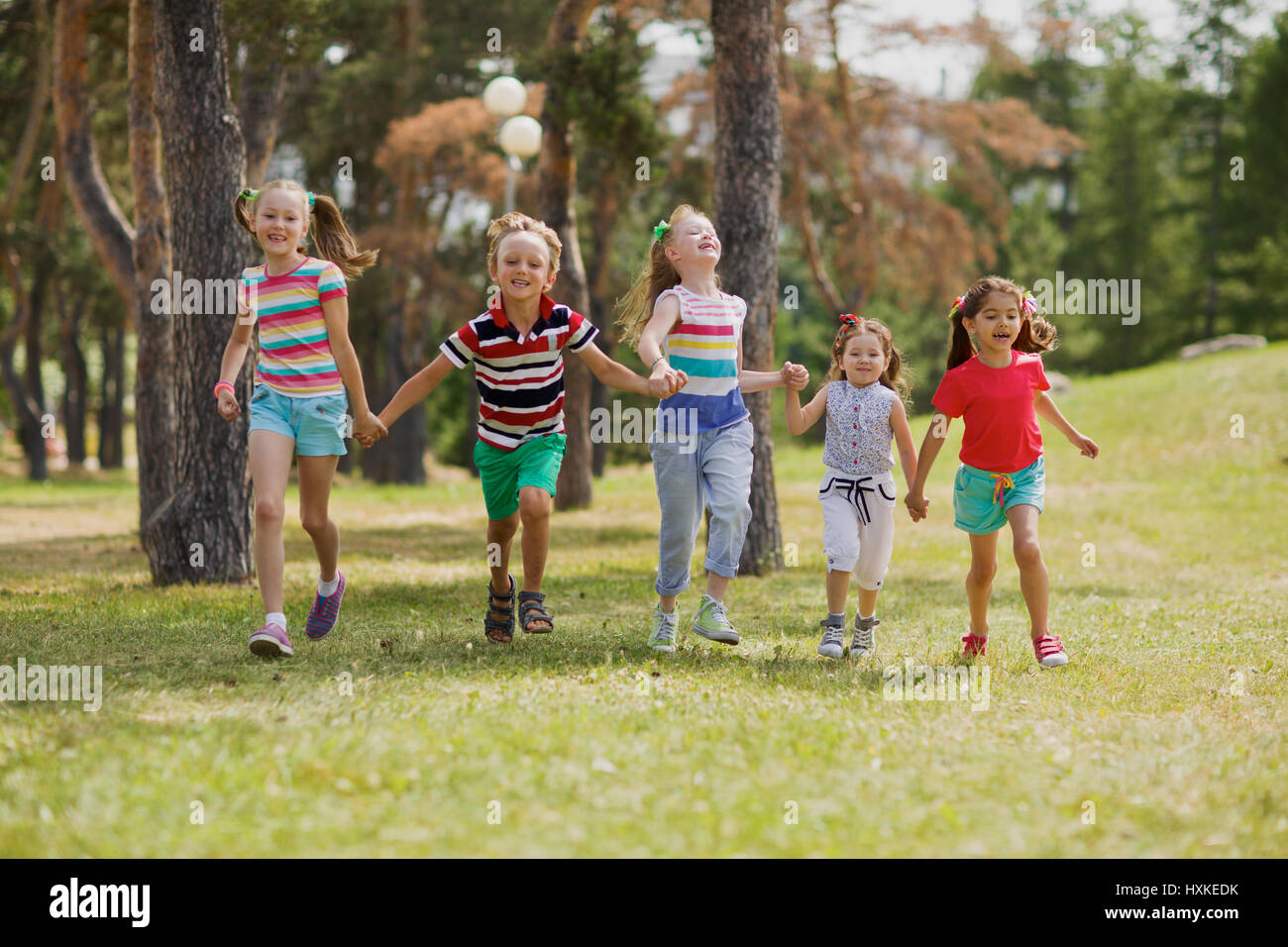Friends walking in park Stock Photo - Alamy